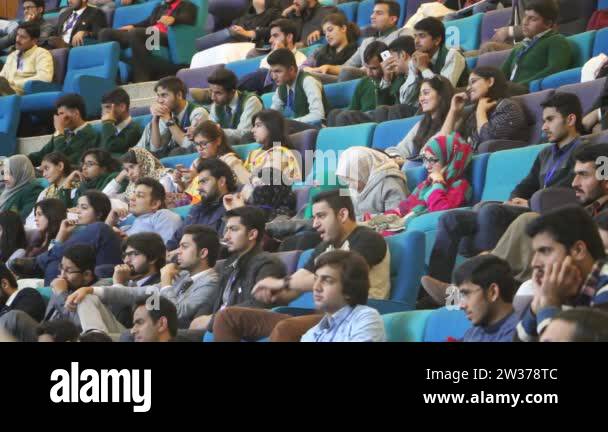 ISLAMABAD, PAKISTAN - DEC 03, 2016: Young crowd listening to ...