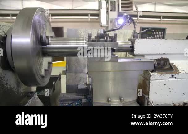 The lathe produces the metal part at the factory. Processing of the ...