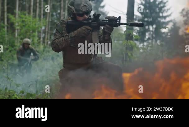 Special Forces soldiers in action. Elite squad moves through fire and ...