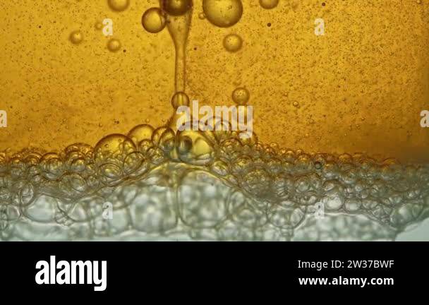 Fuel, yellow, golden oil, poured into a glass vessel in a laboratory ...