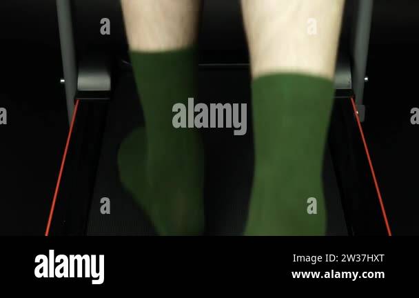 Man feet run walking on the treadmill, to keep body fit and toned ...