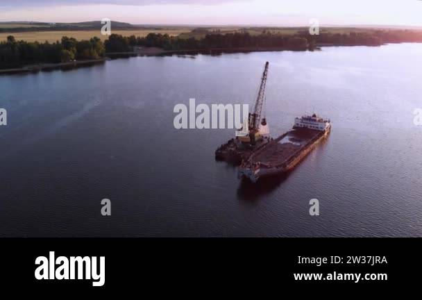 The dredger lifts the sand from the bottom of the river and dumps the ...