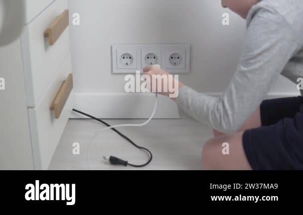 A teenage boy inserts a fork into an outlet Stock Video Footage - Alamy