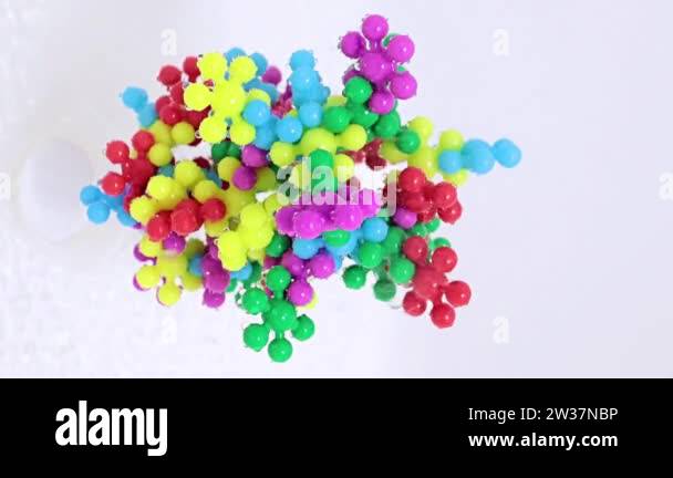 plastic abstract model of a virus molecule in a stream of pure liquid ...
