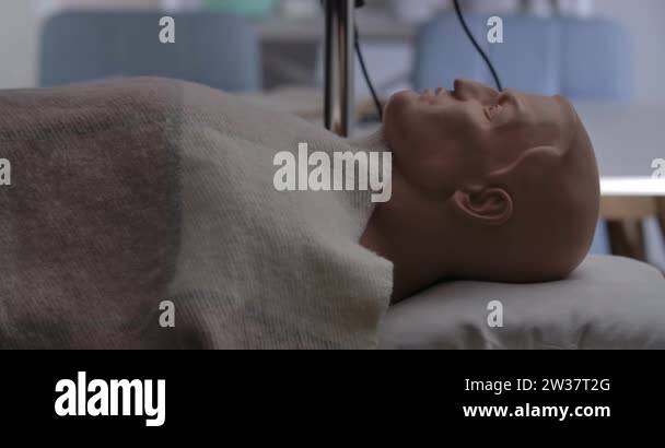 Unrecognizable man practicing first aid on mannequin. Male hands ...