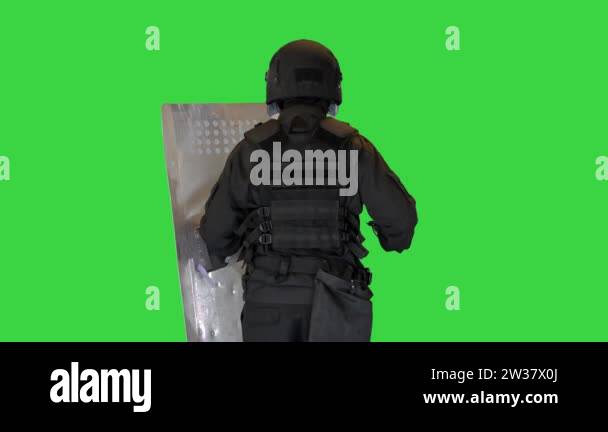 Riot policeman running with a shield and baton on a Green Screen ...