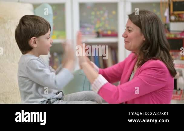 Mother playing and cuddling her son, staying safe at home during the ...