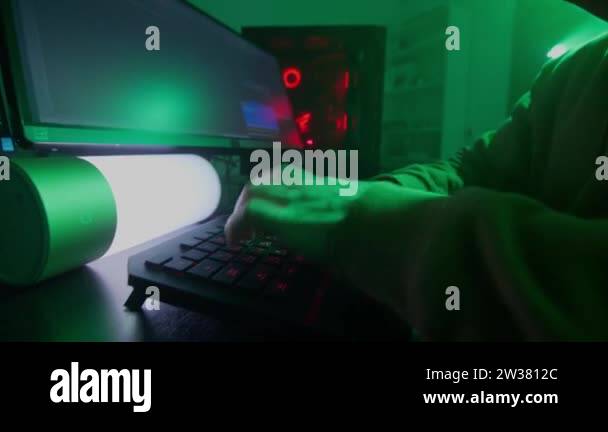 Anonymous person in a white mask works on the computer, inputs code ...