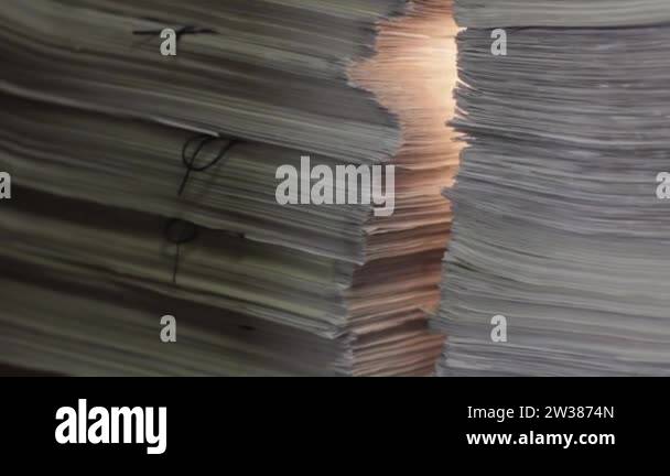 Old business documents are stored in a pile in the archive. Old ...