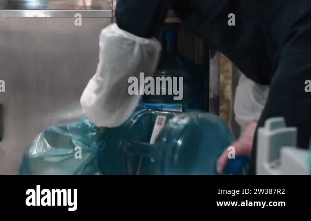 Pure water plant, men in special uniforms and protective masks work ...