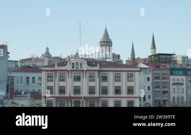 Galata Tower on background of city. Action. Ancient tower towers over ...