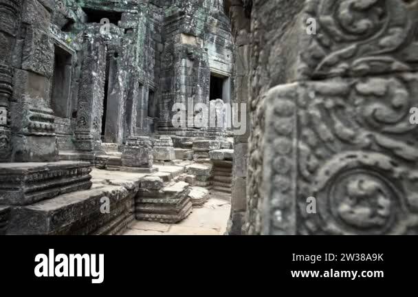 4K, View of ancient stone wall at Bayon temple in Angkor Thom. Face ...