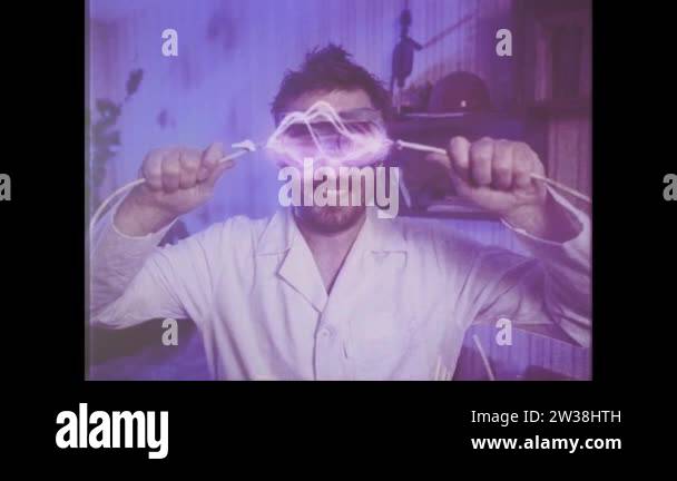 Nerd with big glasses in the laboratory. A doctor from the 80s treats ...