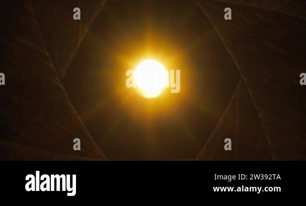 Light rays shining through old camera lens, while diaphragm blades are ...