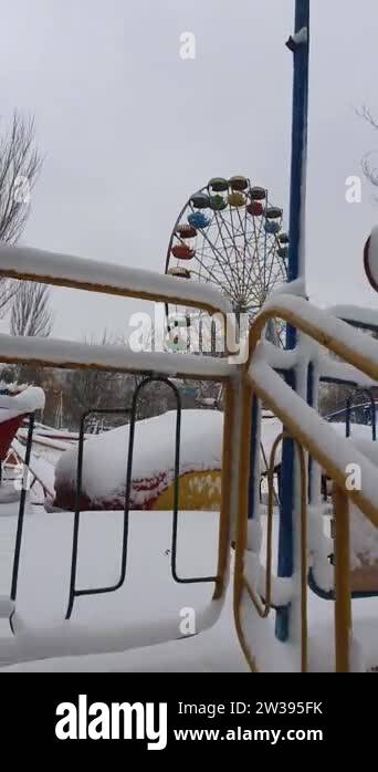 Vertical shot abandoned amusement park. Old, rusty ferris wheel and ...