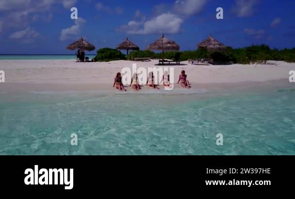 video the tan girls in bikini lying on the white sandy beach and ...