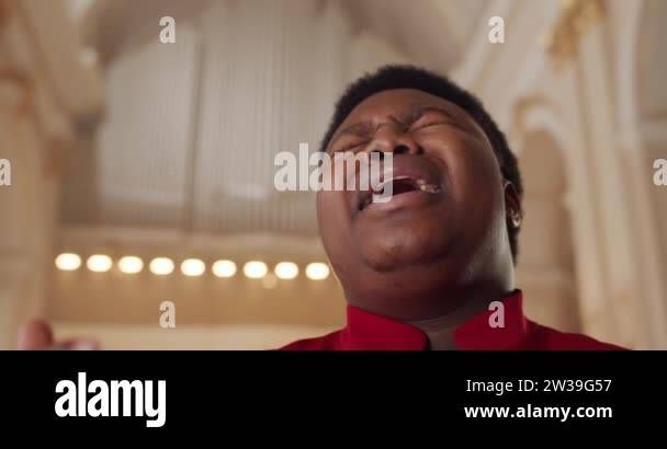Close up view of emotional afro american pastor singing worship ...
