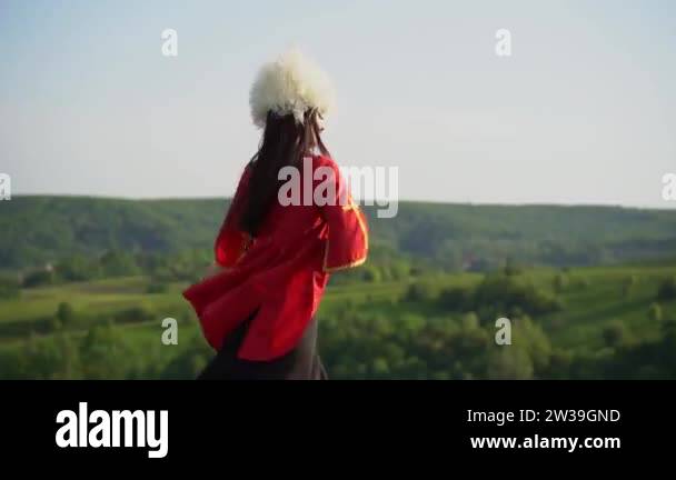Georgian girl in white papakha and red national dress dances national ...