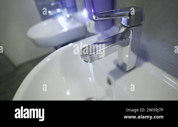 Hot tap water. Warm water flows from the tap in the bathroom ...