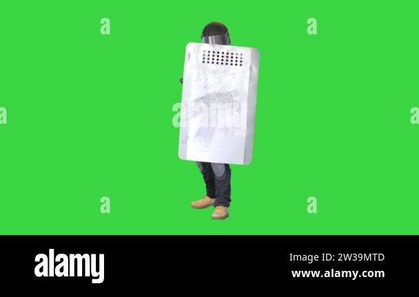 Soldier in full uniform covering with protective shield moving forward ...