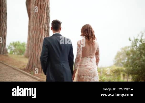 Back view video filming of wedding ceremony of young married couple ...