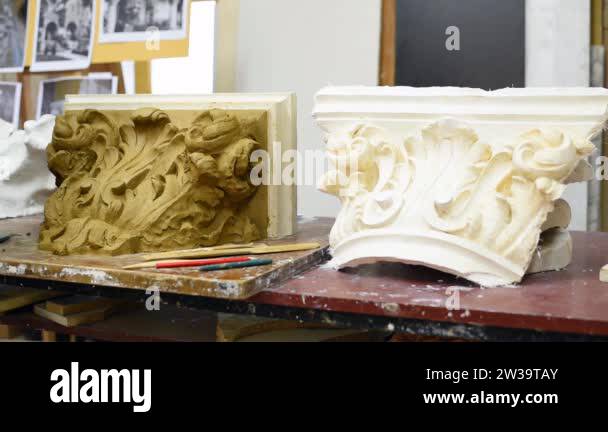 Sculptor create clay model of a Corinthian capitel with scrolls and ...
