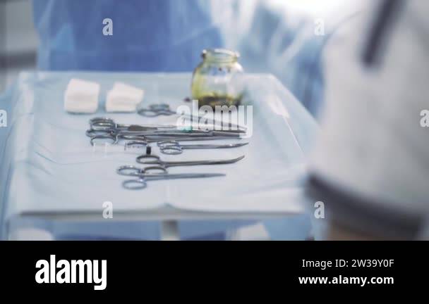 Close up of surgical table with instruments. Action. Medical sterile ...