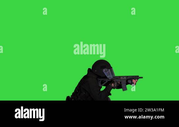 Special forces unit shooting from sitting position on a Green Screen ...