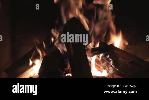 The big fire with firewood in a fireplace, bonfire burning, Brick walls ...