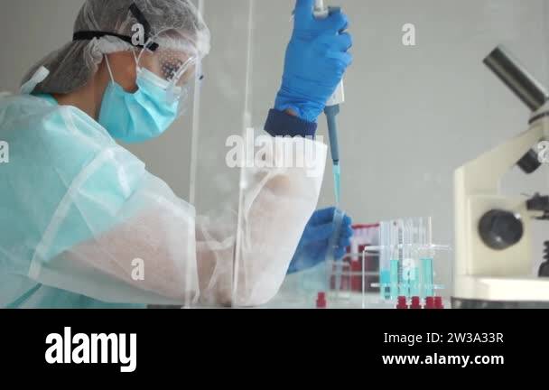 Microbiologist works in the laboratory with reagents and blood samples ...