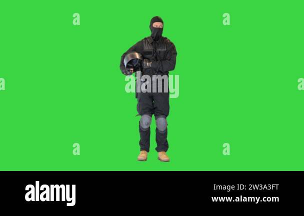 Riot policeman standing holding his helmet in hands on a Green Screen ...