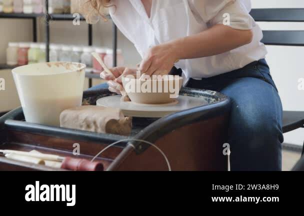 Potter makes the clay product with pottery modeling tools on the ...