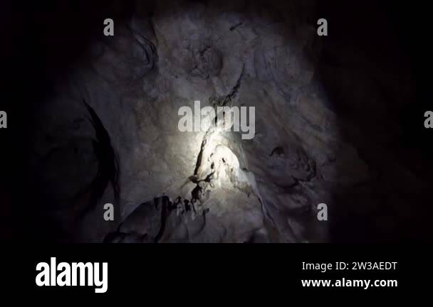 4K, Dark Cave with many formations like stalactites, stalagmites and ...