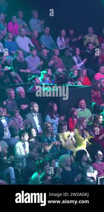 People viewers in a TV studio while recording a TV show. Vertical video ...