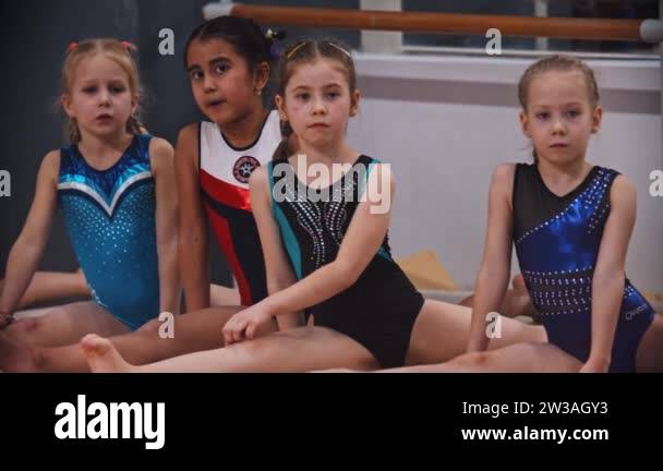 RUSSIA, KAZAN 27-12-20: group of gymnastic girls stretching their legs ...