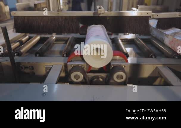 A roll of wallpaper on a conveyor line. Roll of wallpaper. Conveyor ...