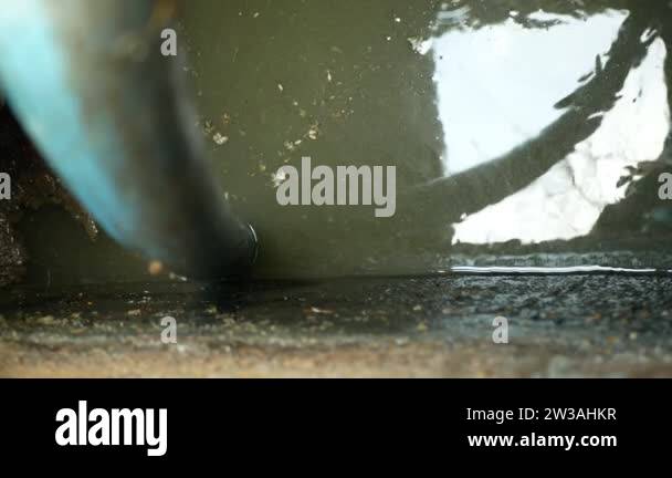 Cesspool pipe septic emptying pumping into tank by suction hose under ...