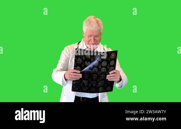 Doctor in a rush viewing MRI scans while walking on a Green Screen ...