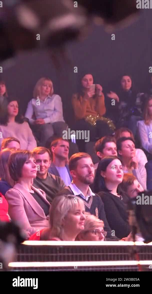 People viewers in a TV studio while recording a TV show. Vertical video ...