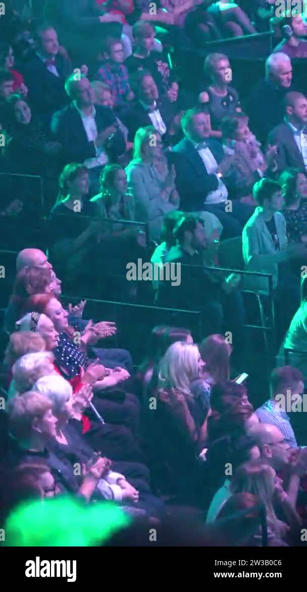 People viewers in a TV studio while recording a TV show. Vertical video ...
