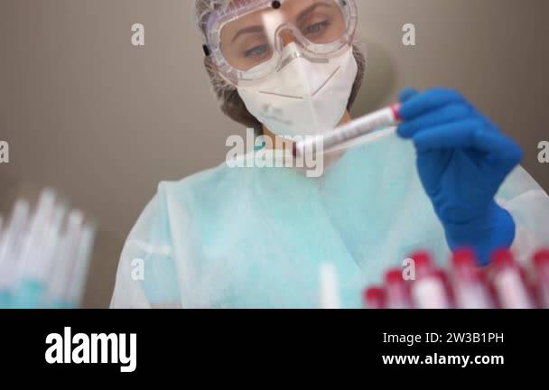Portrait of a laboratory assistant girl in a science lab with a blood ...