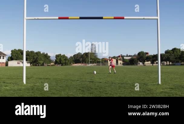 Front view of a teenage Caucasian male rugby player wearing a red and ...