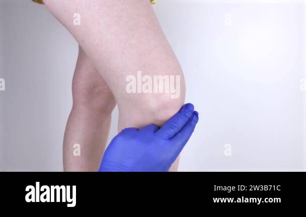 A woman suffers from knee pain. Examination by an orthopedist and ...