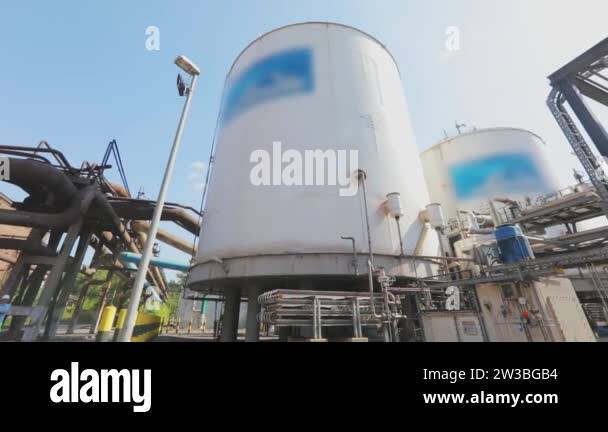White storage tanks for liquids in a modern factory. Large storage ...