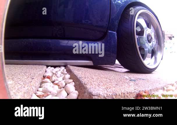 Driving a lowered car on a sloping car park Stock Video Footage - Alamy
