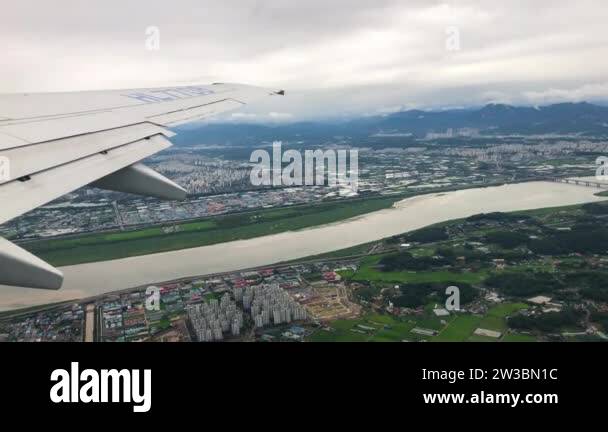 Looking through window aircraft during flight next to the wing with sky ...