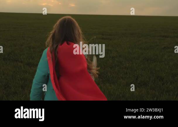 young girl playing super heroes. child play knights. girl in a red ...