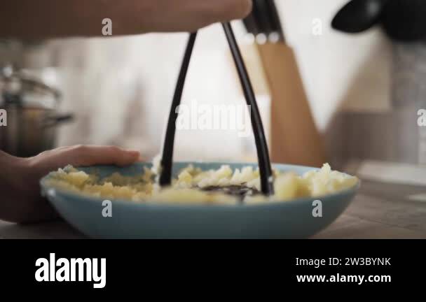 Close up of process of making mashed potatoes. Action. Woman hands ...
