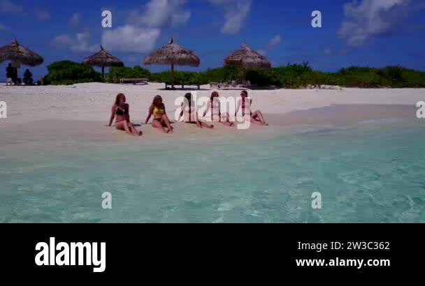 video the tan girls in bikini lying on the white sandy beach and ...