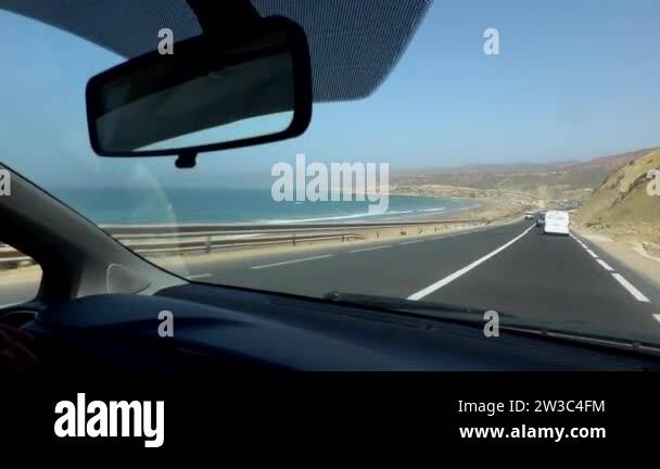 Driving along the sea road and watching the coast line through the ...